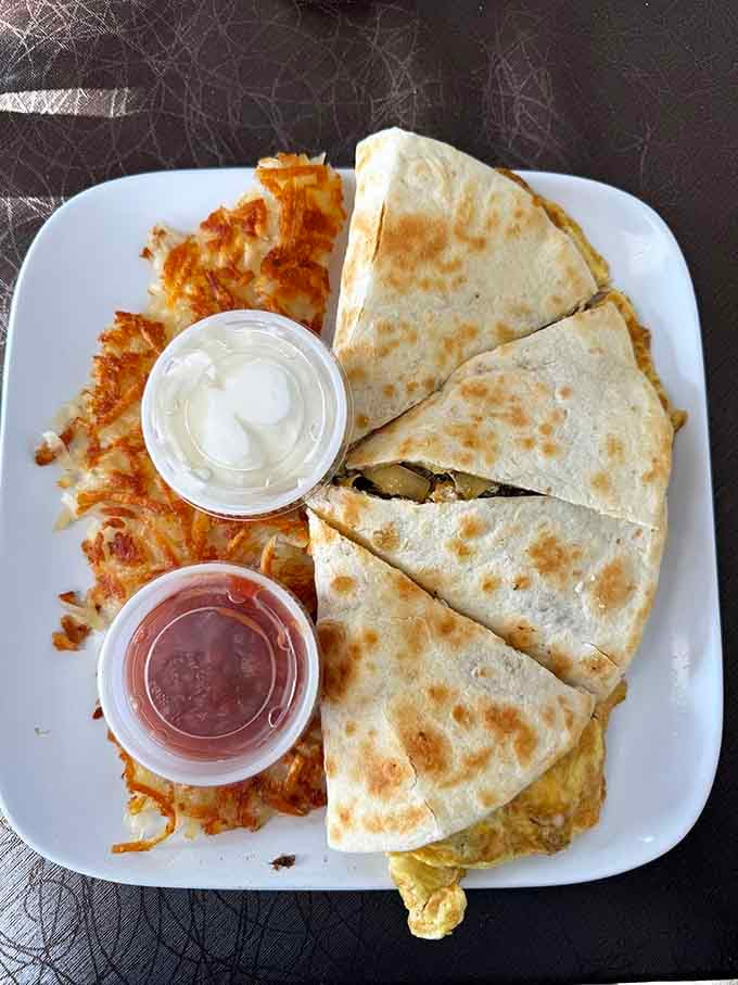 That quesadilla folded around scrambled eggs proves breakfast doesn't need to follow traditional rules to be brilliant.