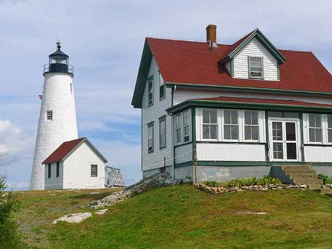 The keeper's house sits pretty with its red roof, looking like it wandered out of a coastal postcard.