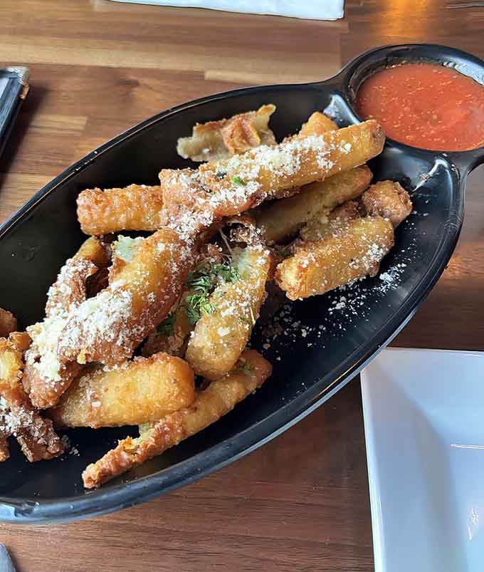 Fried zucchini sticks arrive dusted with parmesan, proving that vegetables can absolutely be part of your gaming fuel.