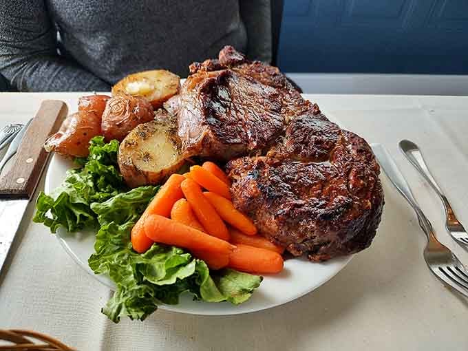 That perfect medium-rare ribeye with golden potatoes and crisp carrots is what steakhouse dreams are made of.