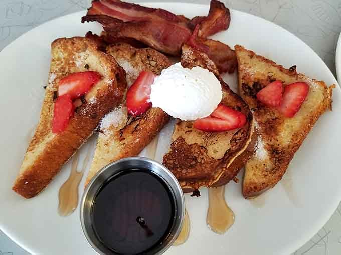 French toast so golden and fluffy, it practically glows with buttery, syrupy perfection on the plate.