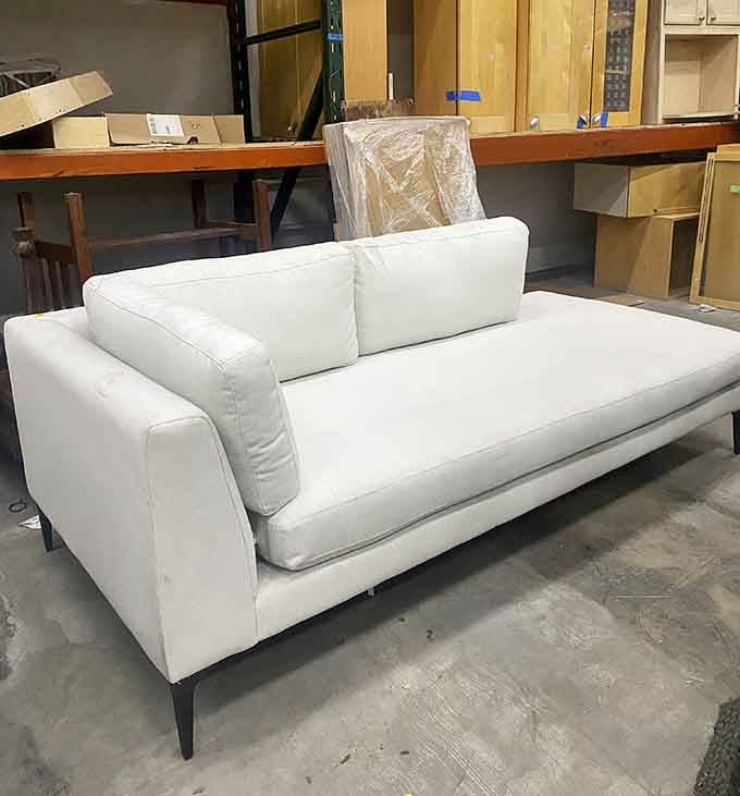 A sleek modern sofa that's cleaner than your conscience and ready for its second act in life.