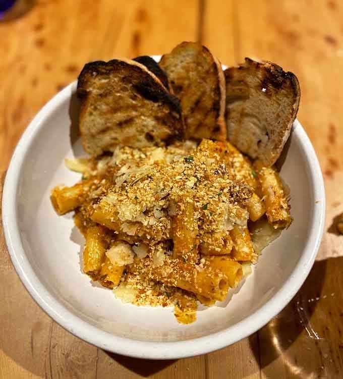 Golden pasta with toasted bread soldiers standing at attention, ready to soak up every bit of that bolognese goodness.