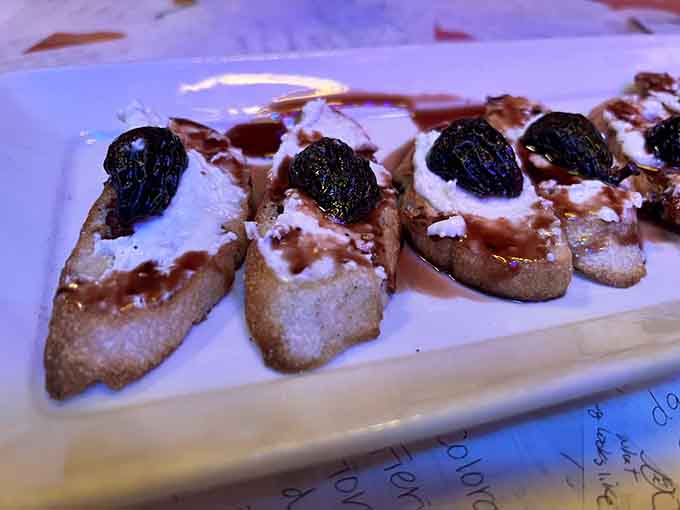 Golden bruschetta topped with figs and prunes delivers sweet and savory notes that dance across your palate.
