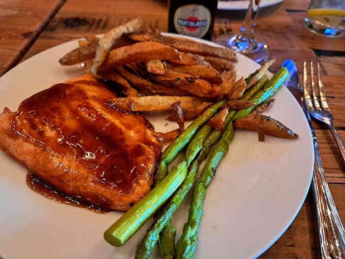 Teriyaki salmon with asparagus and sweet potato fries shows this tavern's range extends far beyond typical pub fare.