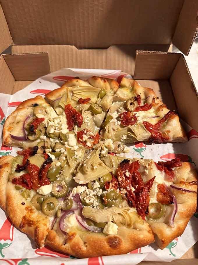 Greek pizza loaded with Mediterranean goodness, proving olives and feta belong on every carb-based canvas.