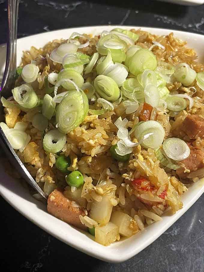Cajun fried rice topped with scallions proves that comfort food knows no cultural boundaries here.