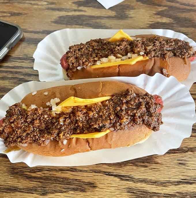 Two chili cheese dogs proving that sometimes excess is exactly what the doctor didn't order but should.