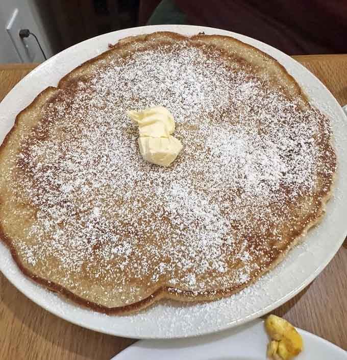 That powdered sugar dusting on a plate-sized pancake is basically edible happiness, and yes, you deserve this kind of joy.