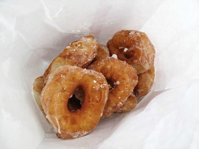 Fresh from the fryer, these golden beauties are still warm enough to make the glaze shimmer seductively.