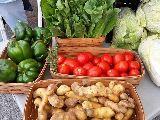 Fresh potatoes still wearing their farm dirt like badges of honor, surrounded by greens that were growing yesterday morning.
