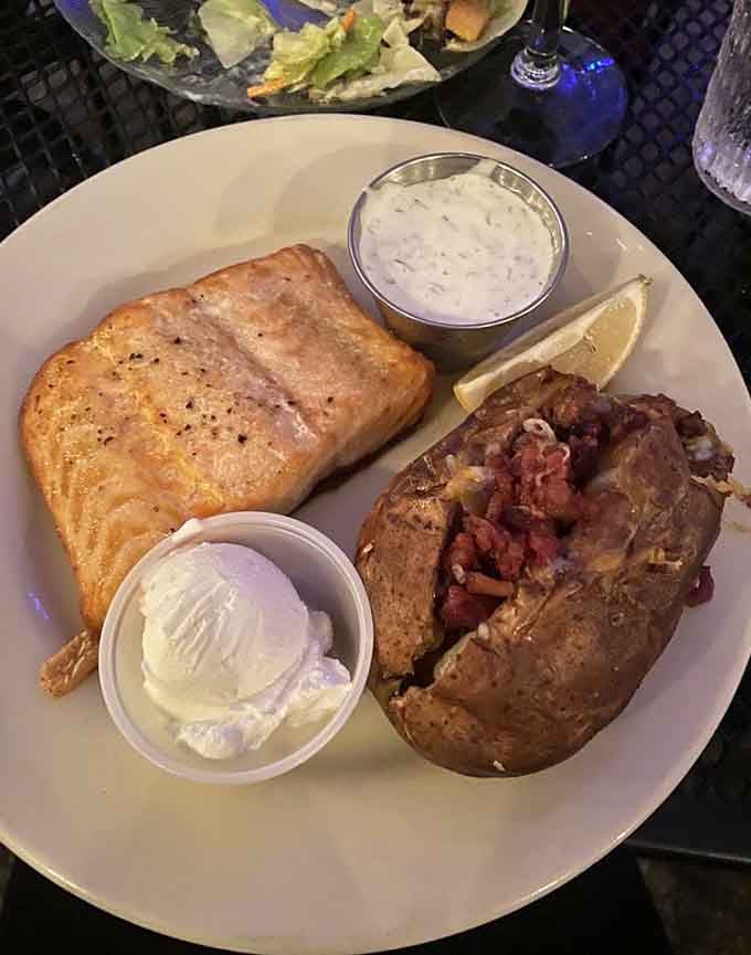 Salmon so perfectly cooked it practically melts on your fork, paired with a loaded baked potato for good measure.