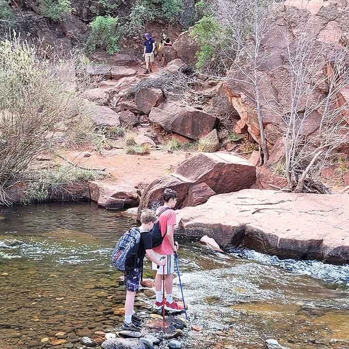 The trail winds through red rock terrain where every turn reveals another reason to stop and catch your breath.