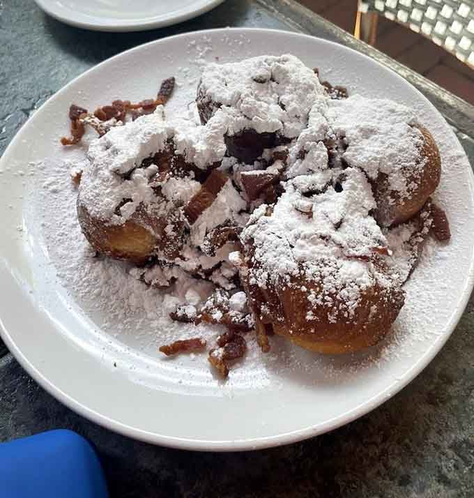 Maple bacon beignets dusted with powdered sugar prove that some of life's best ideas come from breaking all the rules.