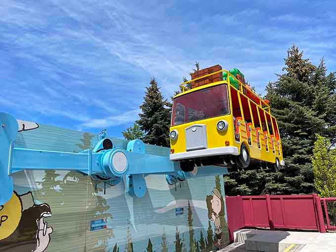 Snoopy's school bus takes flight because apparently even fictional beagles understand that regular transportation is overrated in amusement parks.