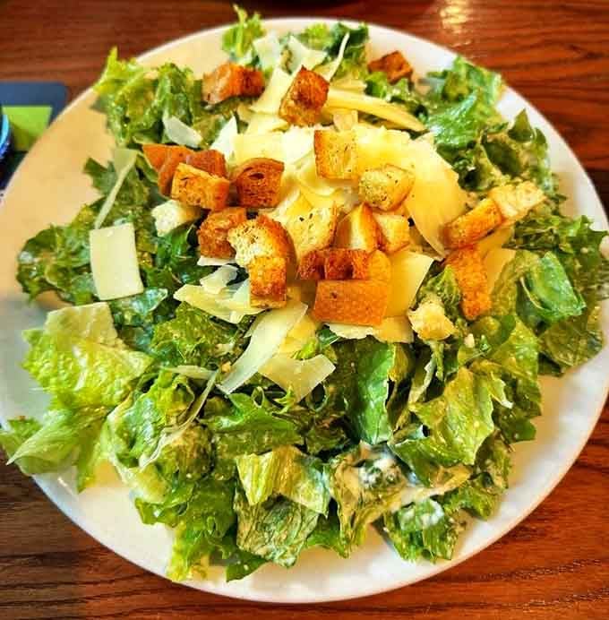Fresh romaine, shaved Parmigiano-Reggiano, and house-made dressing prove that even salads get the royal treatment here.