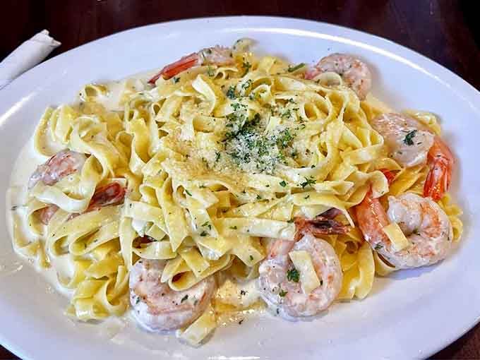 Shrimp Alfredo delivers creamy indulgence with tender seafood nestled in fettuccine, comfort food at its finest hour.