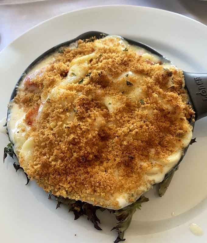 Bubbling cheese meets tender lobster in a cast-iron skillet that's basically edible heaven with a breadcrumb crown.