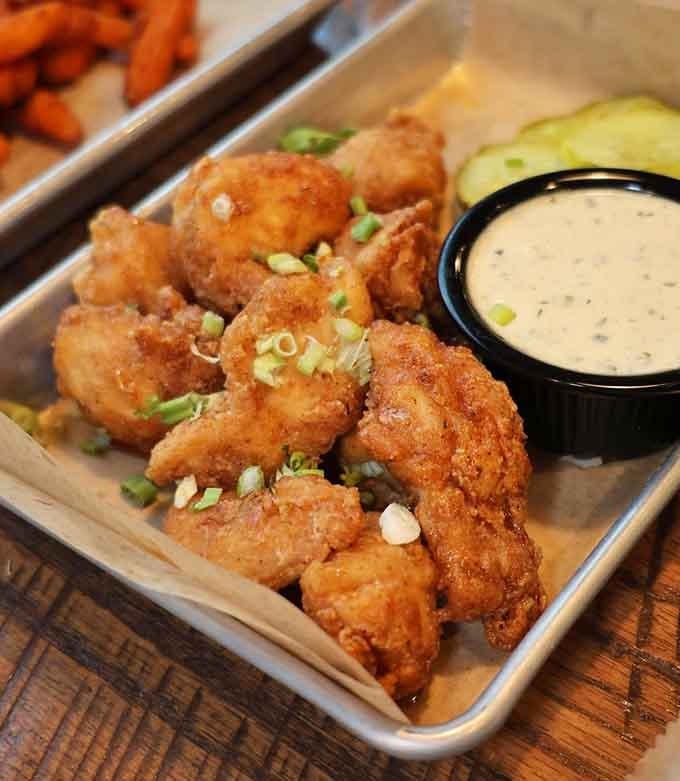 These golden, crispy Sriracha Honey Chicken Bites pack sweet heat that'll have you ordering seconds immediately.