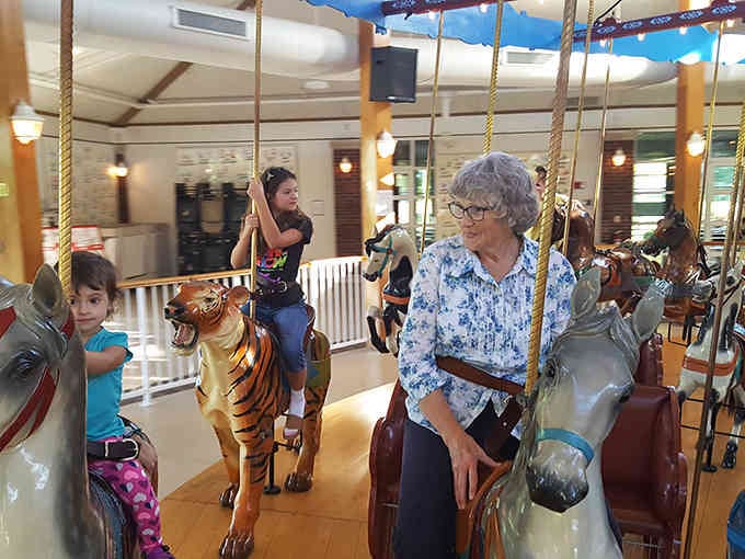 Three generations sharing one magical moment &ndash; grandma's smile says she remembers riding this exact tiger decades ago.