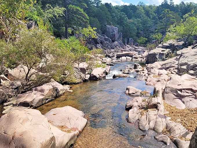 Natural pools carved by time itself create swimming spots that no architect could ever dream up or replicate.