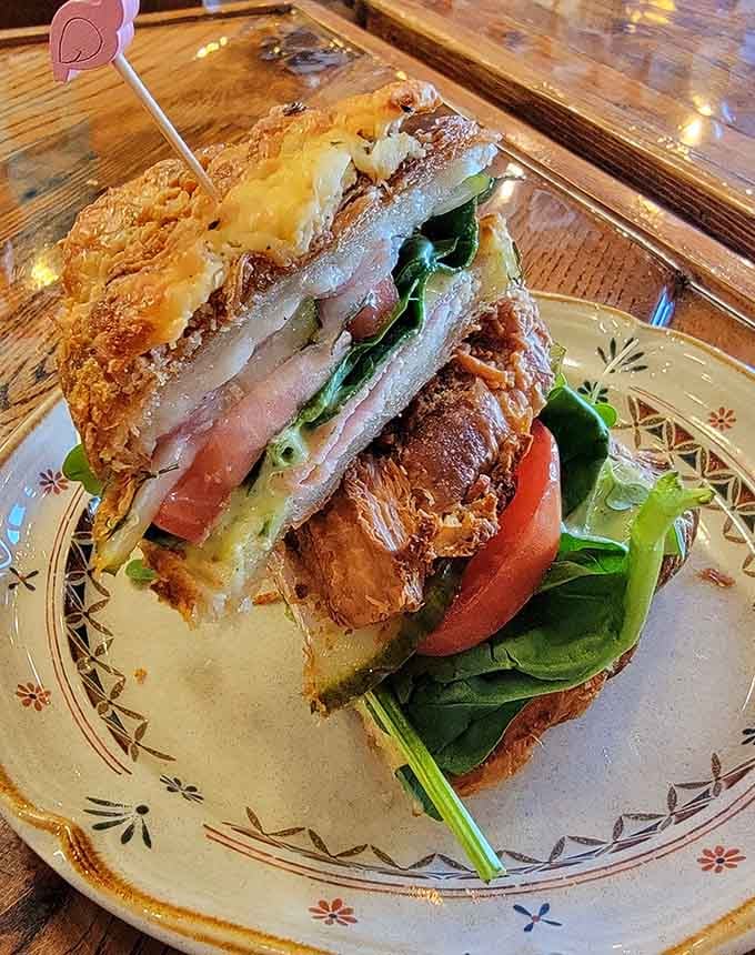 This towering sandwich situation proves that sometimes architectural ambition in breakfast is absolutely worth celebrating enthusiastically.