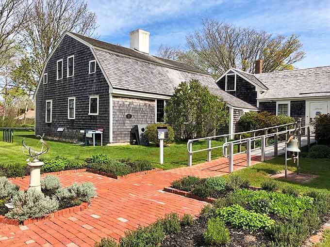 The Atwood House's weathered shingles and brick walkway whisper stories from 1752, when "new construction" meant something entirely different.
