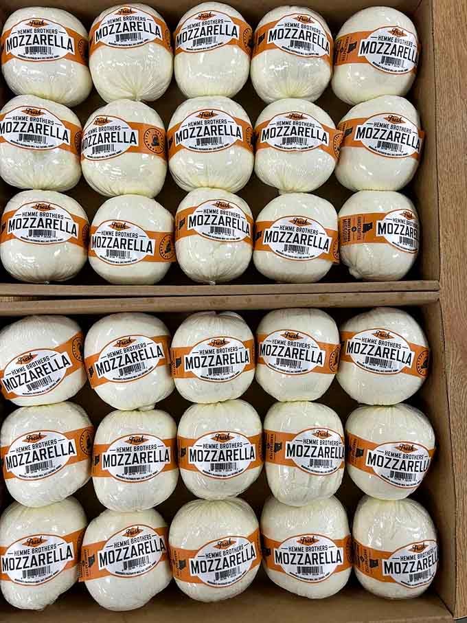 Fresh mozzarella balls lined up like edible pearls, ready to transform your caprese salad into something extraordinary.