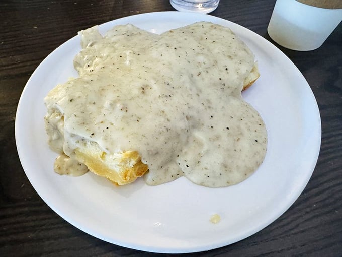 Creamy sausage gravy cascading over flaky biscuits like a delicious avalanche you'll never want to escape from.