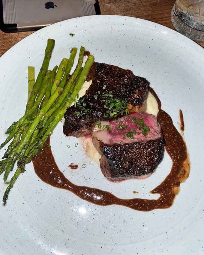 Perfectly seared steak with asparagus proves that fine dining and comfort food can coexist beautifully on one plate.