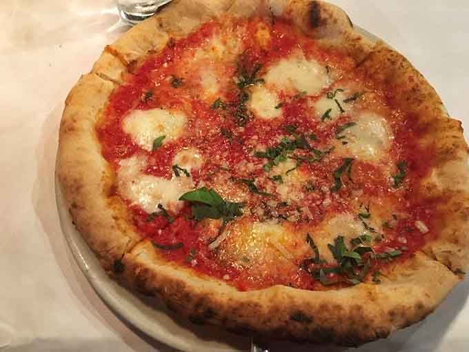 That leopard-spotted crust and bubbling cheese means this Neapolitan pizza came from a seriously hot wood-fired oven.