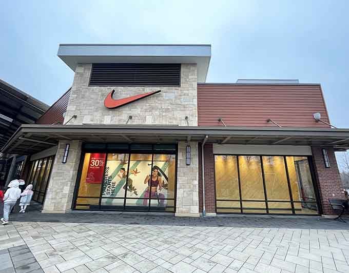 The iconic swoosh beckons shoppers inside where athletic dreams meet wallet-friendly reality, a beautiful combination if there ever was one.