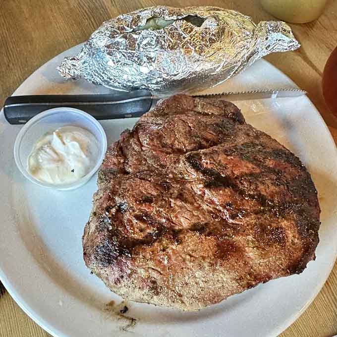 This flame-grilled steak could feed a family, but it's all yours alongside that foil-wrapped potato the size of a football.