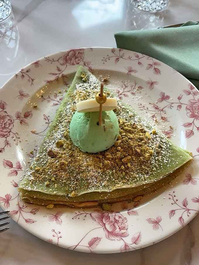 That pistachio green scoop sitting pretty on golden crepe is basically springtime deciding to become dessert for you.