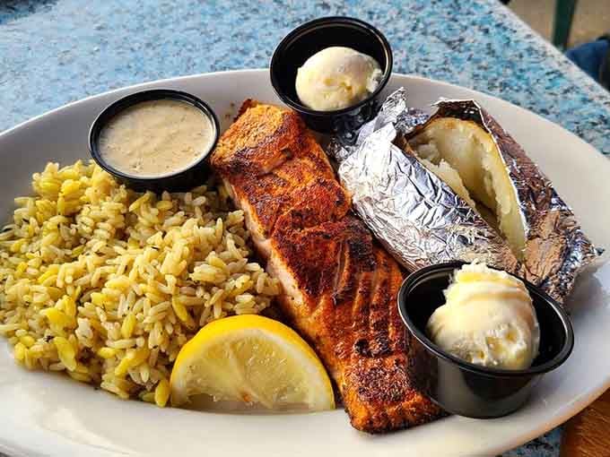 Perfectly seasoned salmon with rice and a loaded baked potato delivers restaurant-quality dining in peaceful surroundings.
