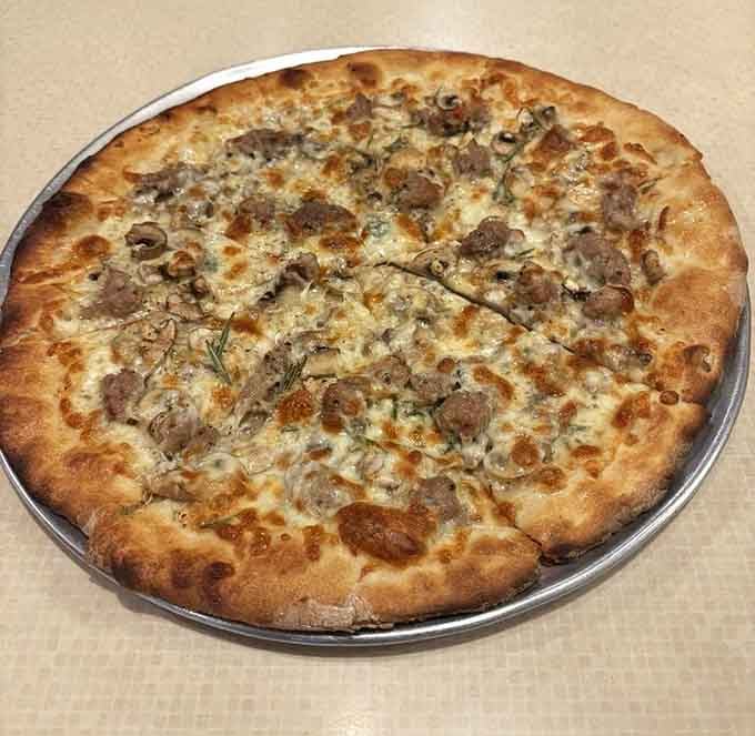 The white pie loaded with sausage proves you don't always need tomato sauce for perfection.