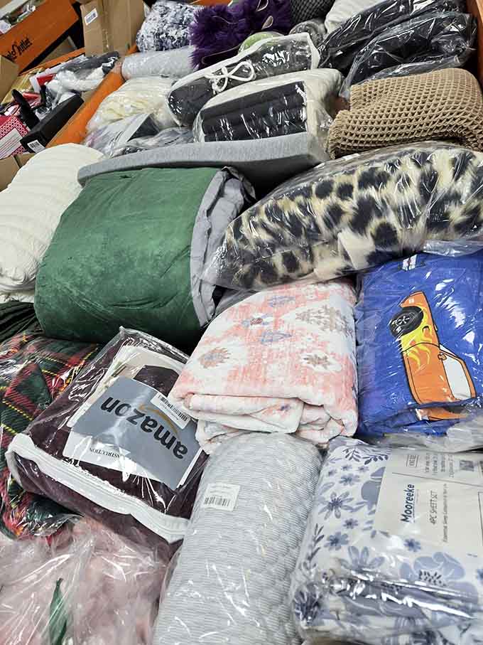 Cozy blankets and bedding stacked high, ready to transform your bedroom without requiring a second mortgage on the house.