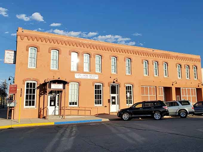 The Windsor Hotel's peach facade glows in the afternoon sun, a testament to architecture that actually had personality.