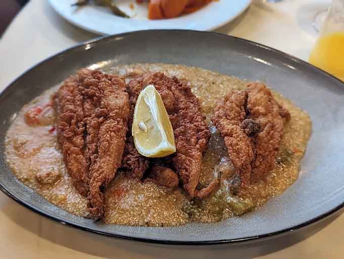 Crispy catfish meets creamy grits in a combination that'll make you question why you ever ordered anything else.