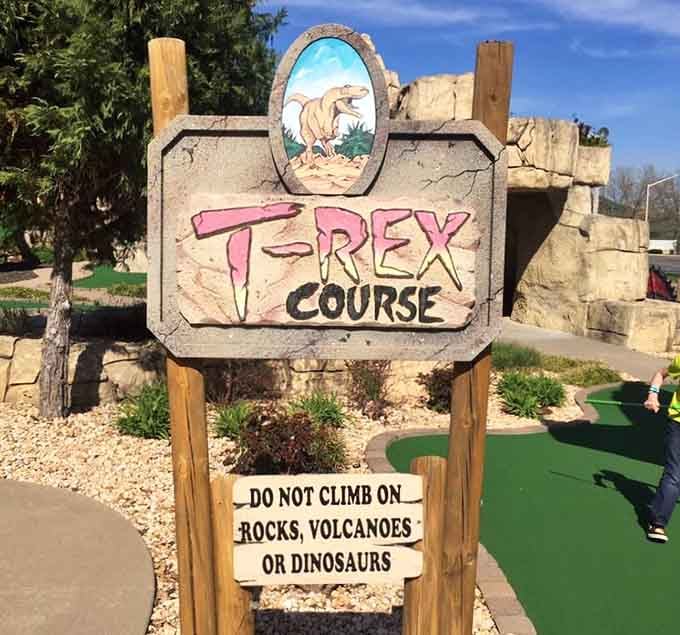The T-Rex Course sign comes with important safety advice: resist the urge to climb on ancient reptiles.