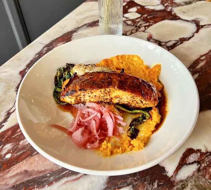 Perfectly seared salmon that looks like it swam straight from the ocean onto your plate this morning.