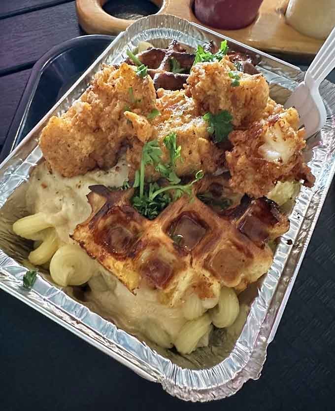 Yes, that's lobster mac and cheese served on a waffle, because sometimes genius looks absolutely ridiculous before it tastes incredible.
