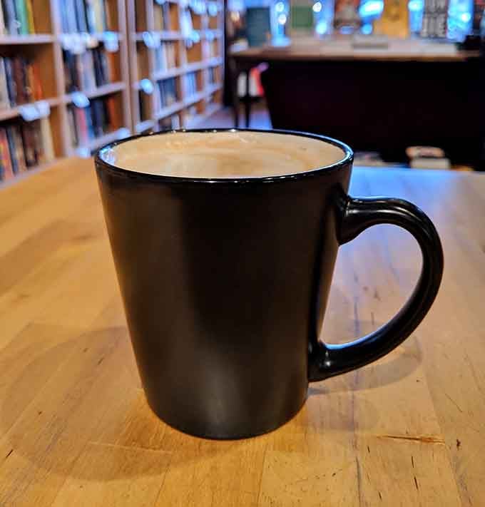 Simple black mug filled with perfectly brewed coffee, the essential fuel for any serious reading session.
