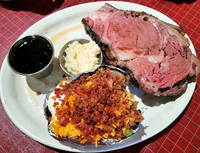 Prime rib so tender it practically melts, paired with a loaded baked potato that deserves its own standing ovation.