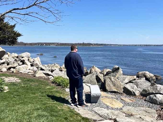 Standing at the water's edge, contemplating life's mysteries, or possibly just wondering if that's a sailboat or a really ambitious kayaker.