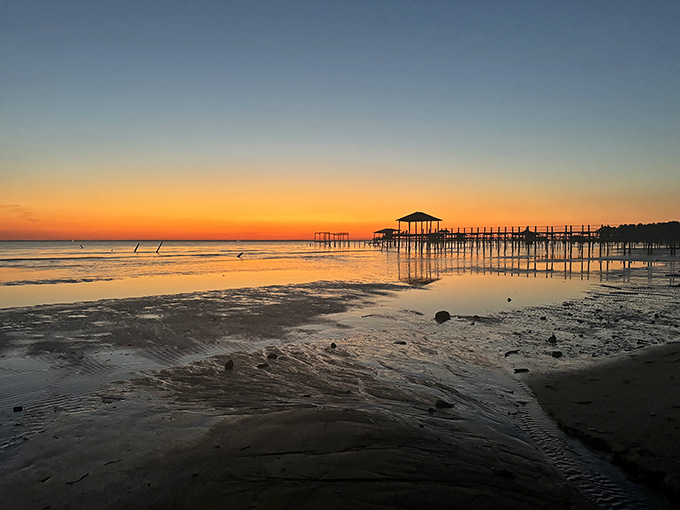 The pier at sunset paints the sky in colors that make even your phone's camera look like a professional.