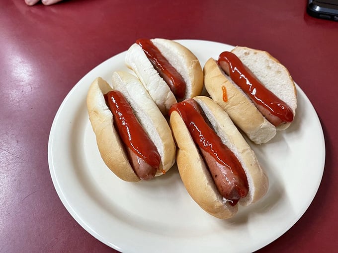 Sometimes simplicity speaks volumes: perfectly grilled mini dogs with just ketchup, ready to disappear in three glorious bites each.