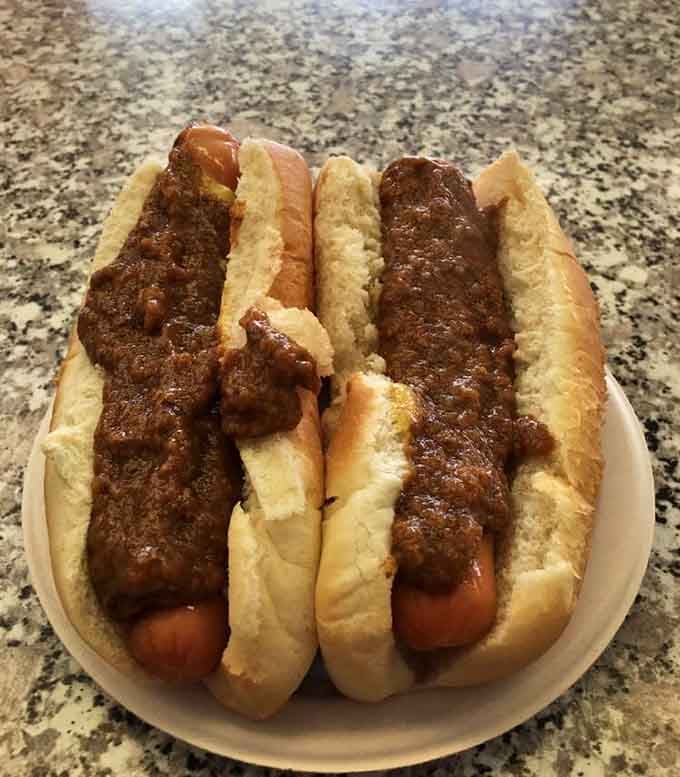 Two hot dogs blanketed in meat sauce so good you'll want to frame this photo and hang it.