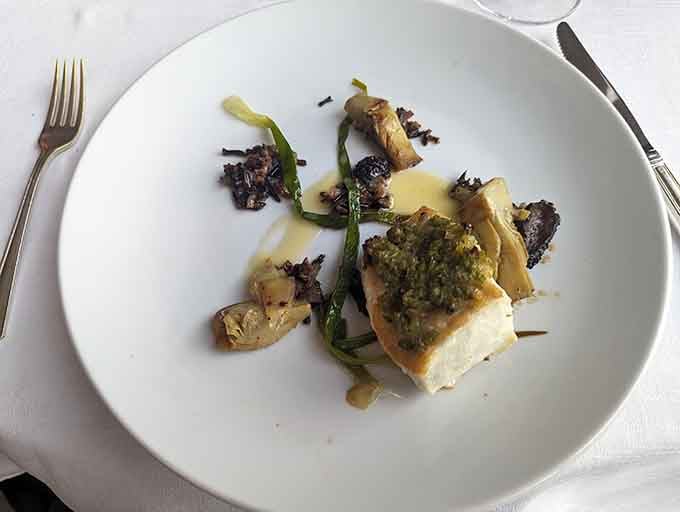 Alaskan halibut making the thousand-mile journey worthwhile, nestled among vegetables that actually taste like vegetables.