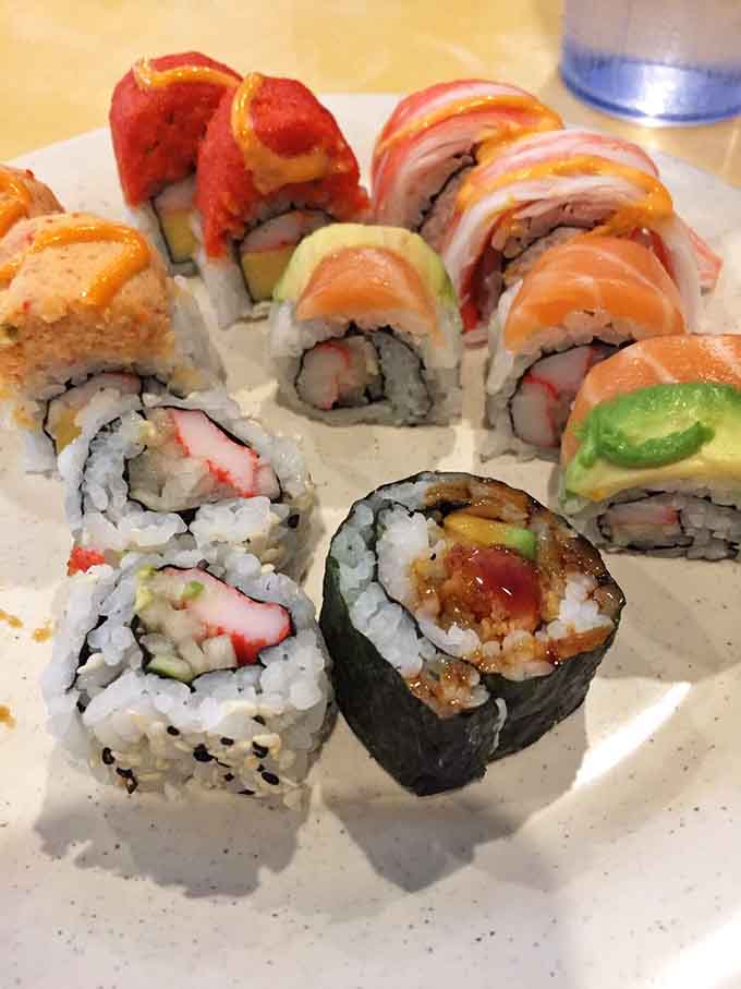 Sushi rolls arranged like edible art, each one a tiny flavor package waiting to make your taste buds do backflips.